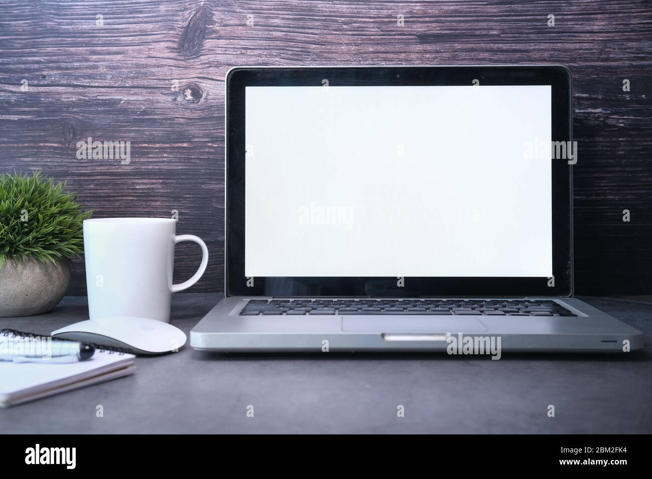Laptop with white screen on office table Stock Photo - Alamy