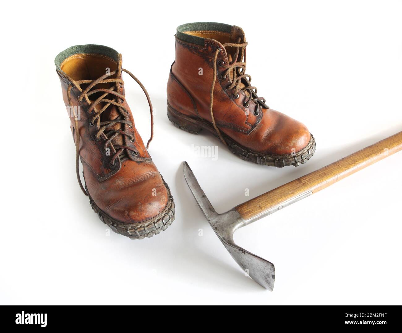 Old mountain boots and Ice Axe isolated on white Stock Photo - Alamy