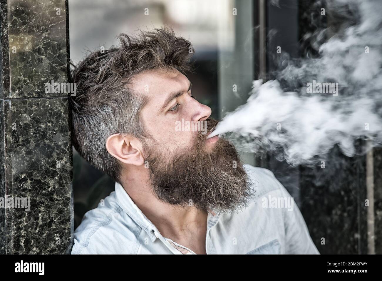 Man with beard and mustache smoking, black marble background. Smoking ...