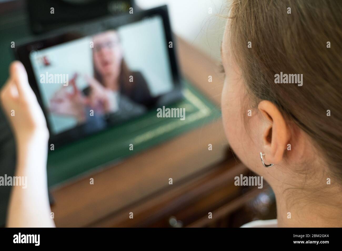 Little girl making video call with school teacher. Distance learning ...