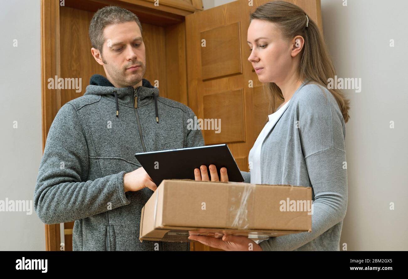 Male courier delivers package. Parcel delivery service Stock Photo - Alamy