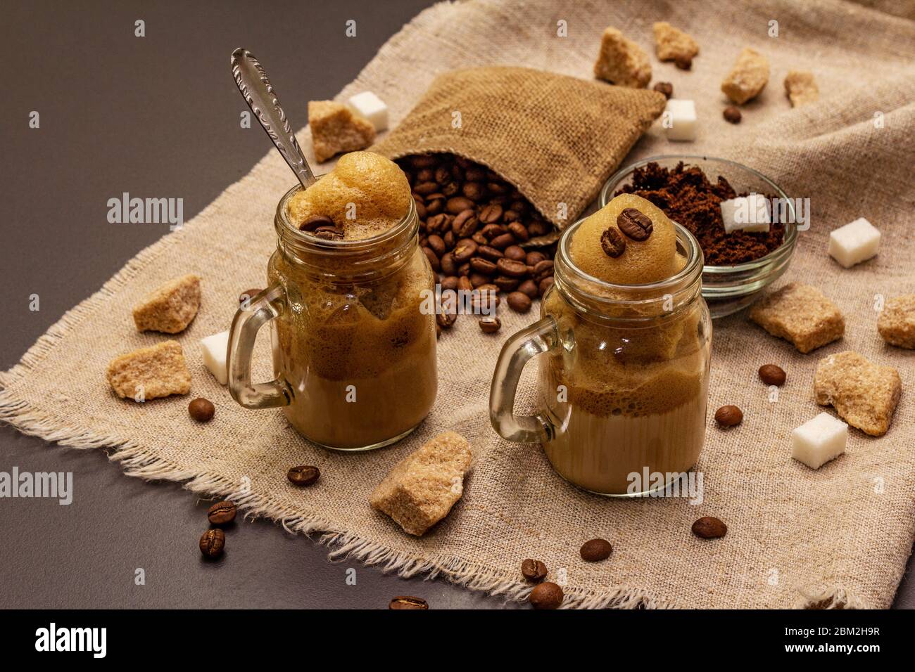 Dalgona coffee in mason jar. Korean fluffy whipped coffee beverage ...