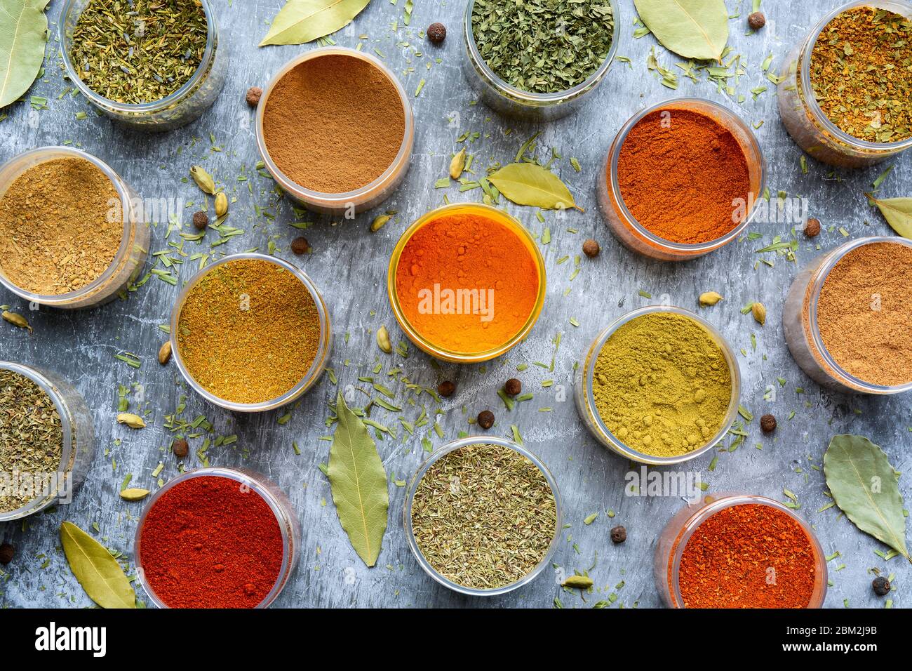 Variety of colorful dried herbs and spices in cups. Selection of herbs ...