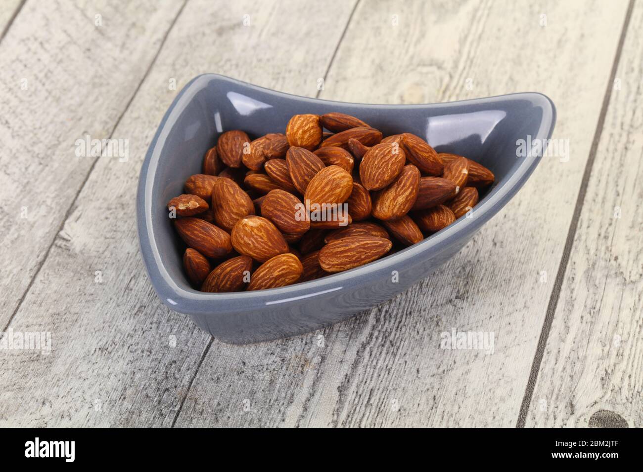 Almonds nuts heap in the bowl Stock Photo - Alamy