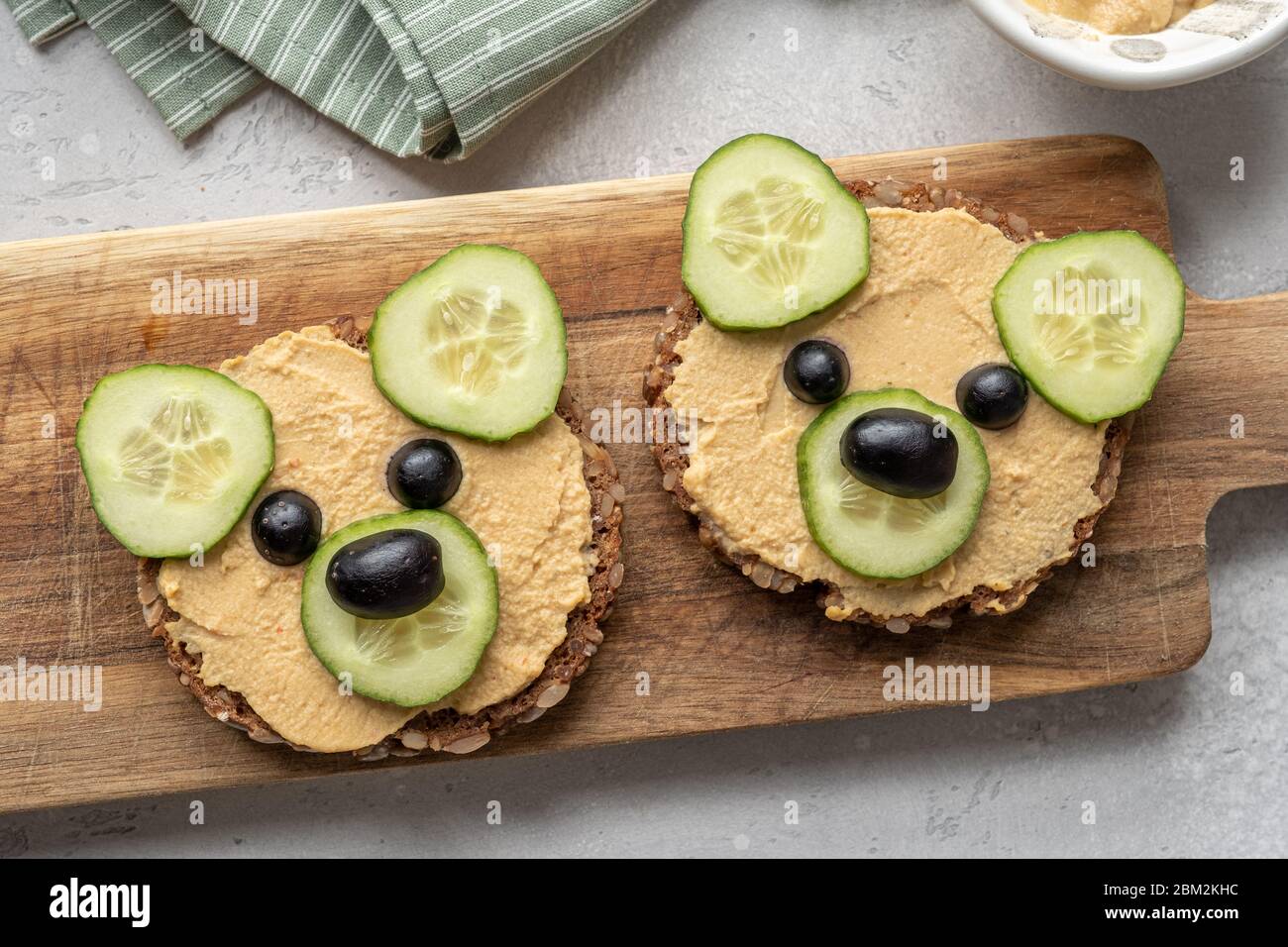 Funny bear toast with cucumber and hummus toasts Stock Photo - Alamy