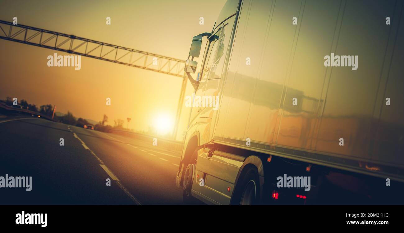 View Of Open Road And Semi Truck On Highway With Yellow Hazy Sunset ...