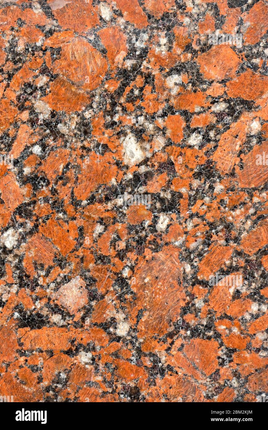 natural drawing of granite surface with rich red hue, coarse-grained ...
