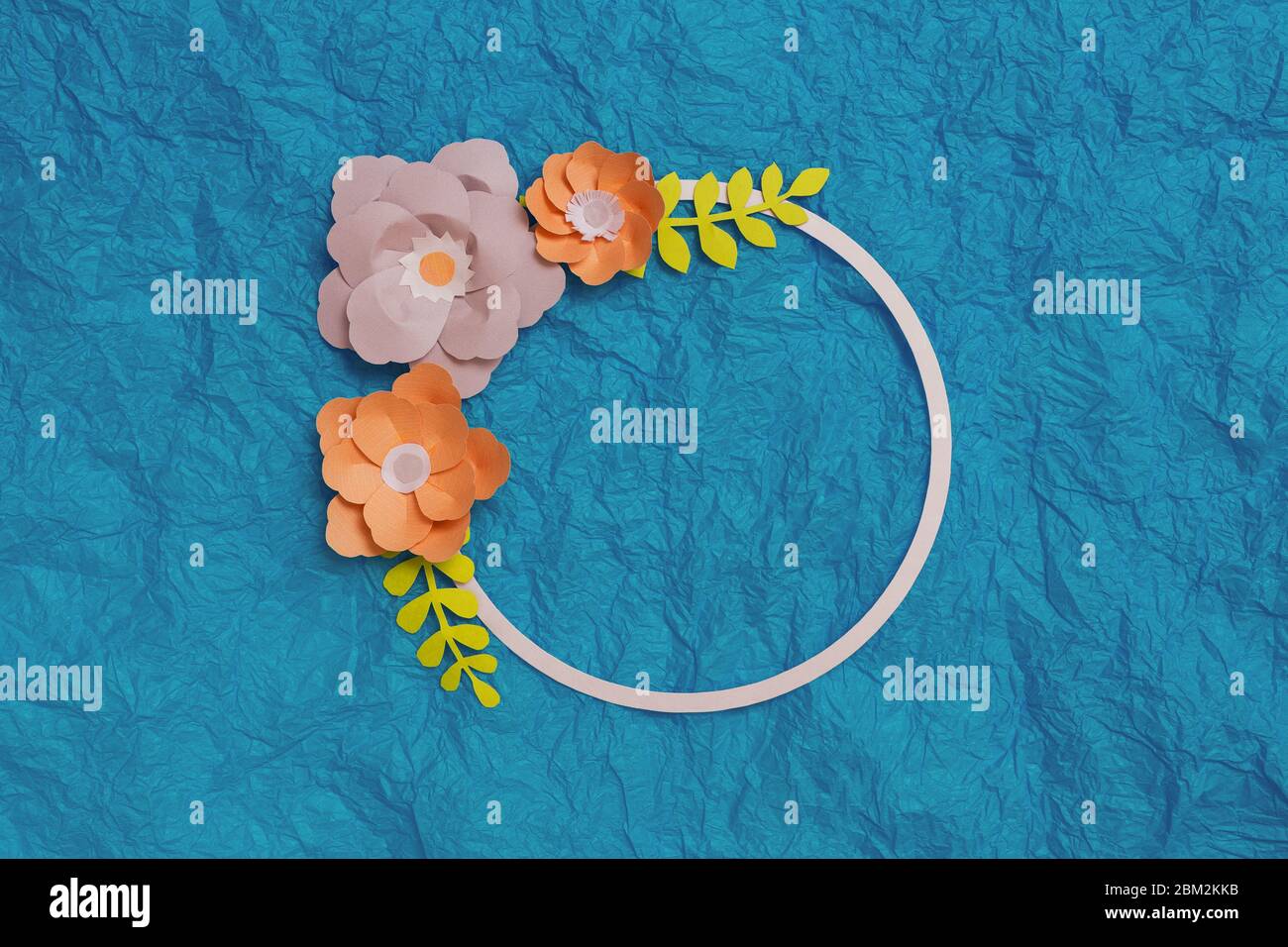 Round frame with orange color paper flowers on blue background. Flat ...