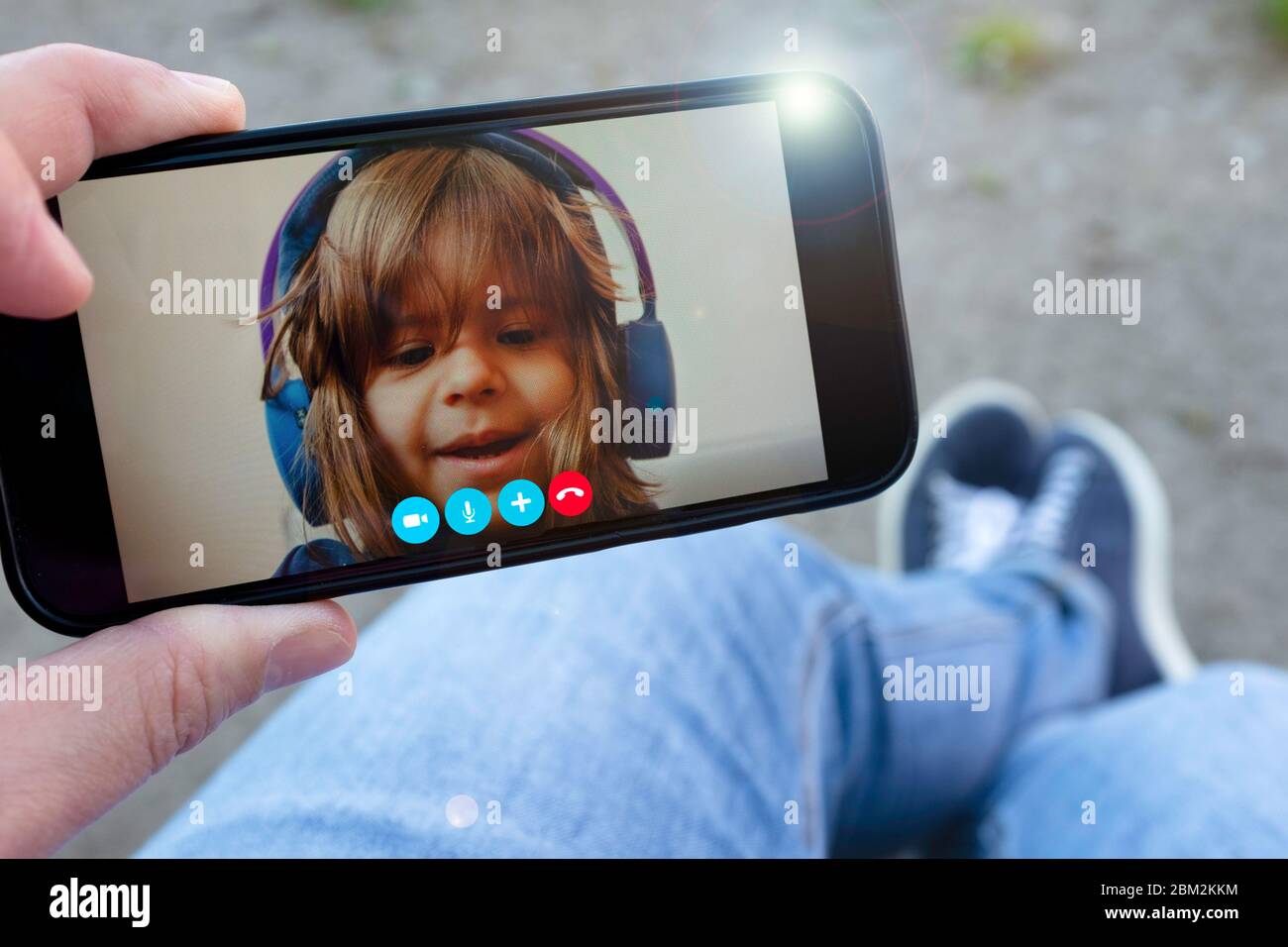 Father and daughter talking to each other through a video call on a ...