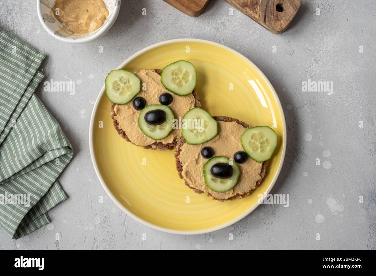 Funny bear toast with cucumber and hummus toasts Stock Photo - Alamy