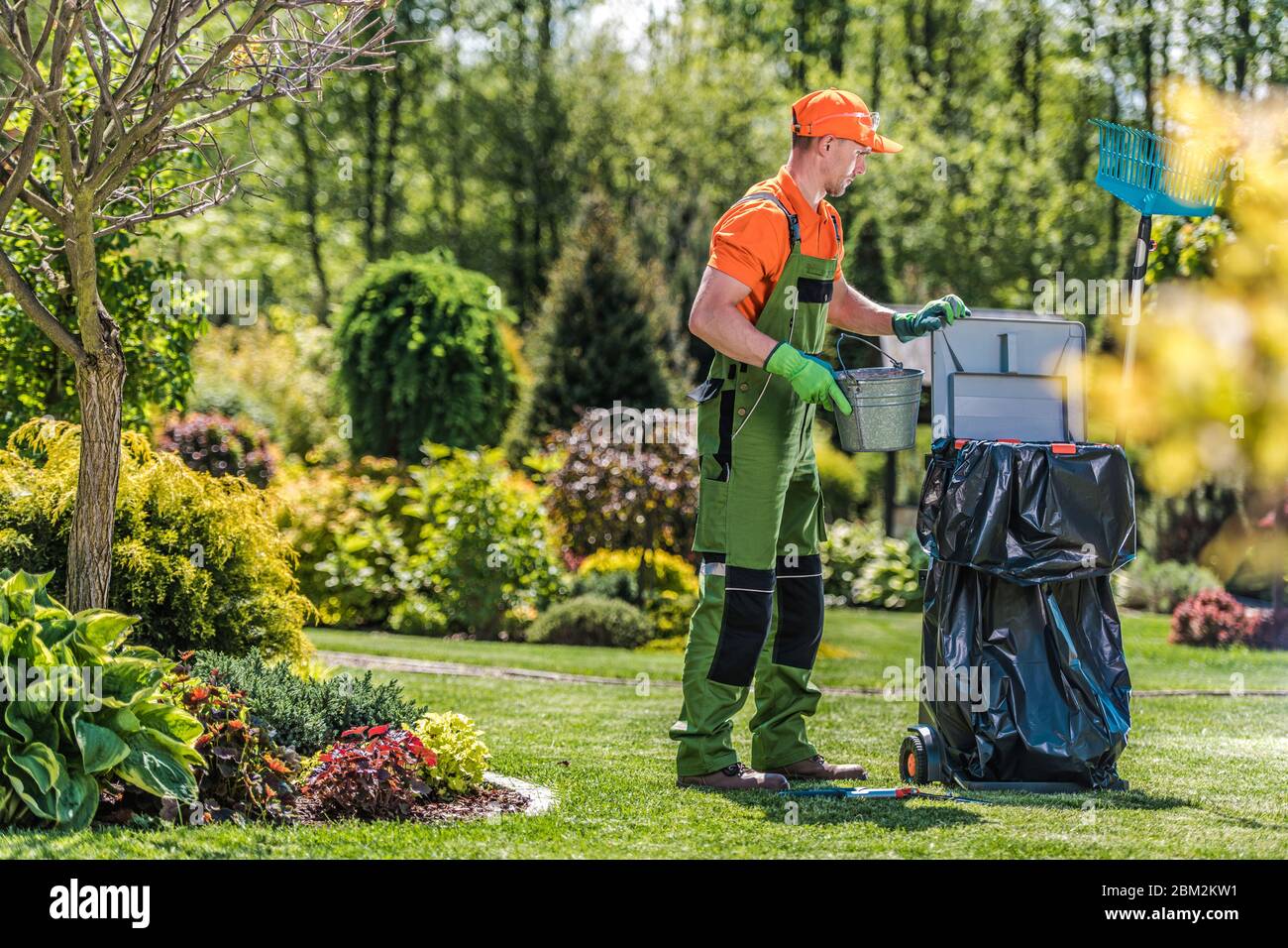 Male Groundskeeper Maintaining And Cleaning Outdoors Area Of ...