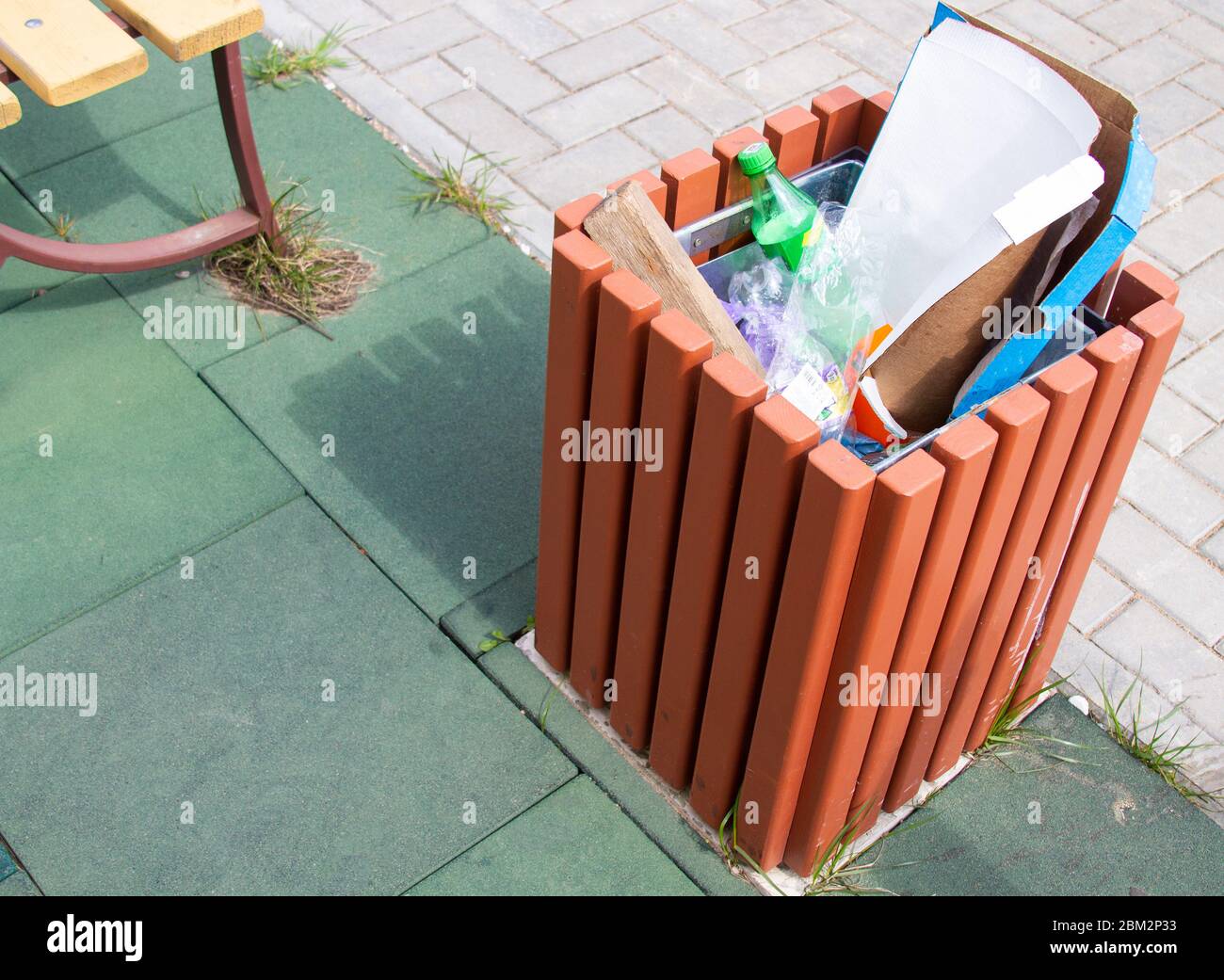 the container is full of garbage with various waste standing on the ...