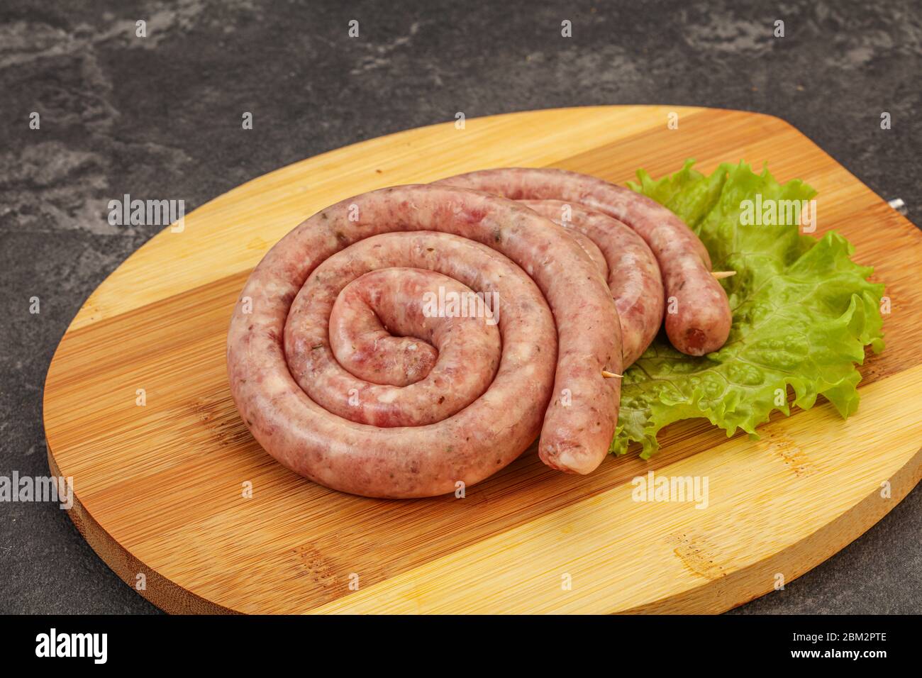 Raw pork sausage ring for grill Stock Photo - Alamy