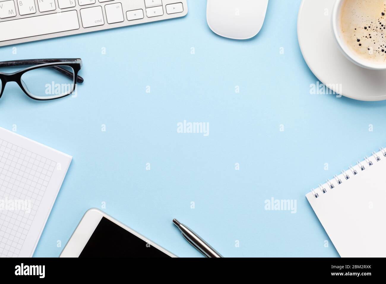 Blue workplace desk table with computer, smartphone, supplies and ...