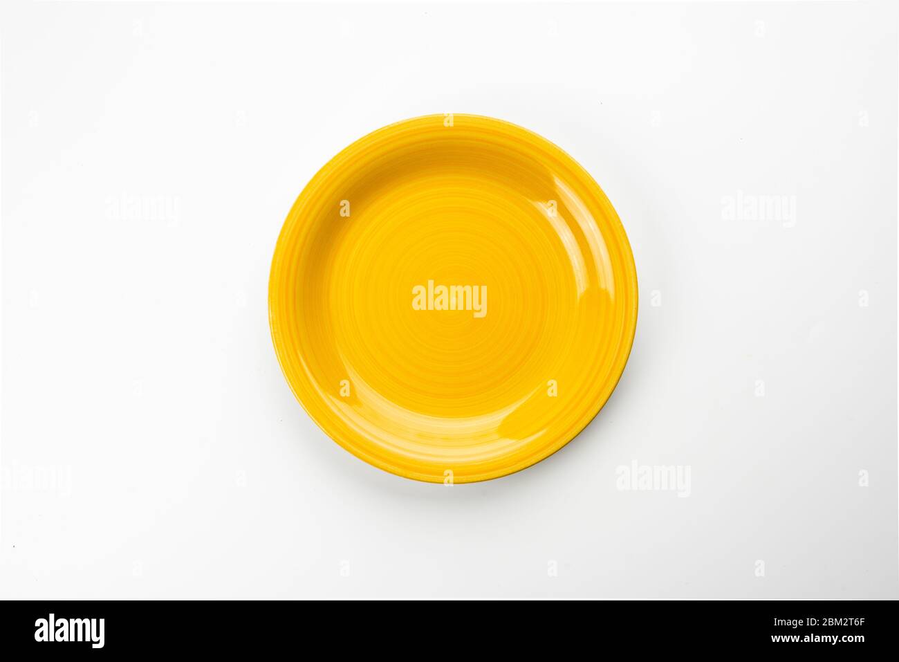 Empty yellow plate isolated on white background Stock Photo - Alamy