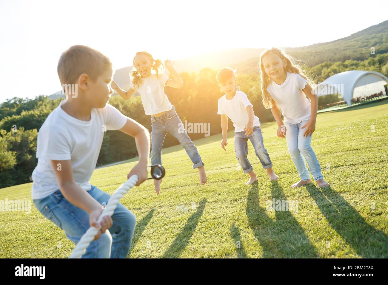 Children have fun playing in nature Stock Photo - Alamy