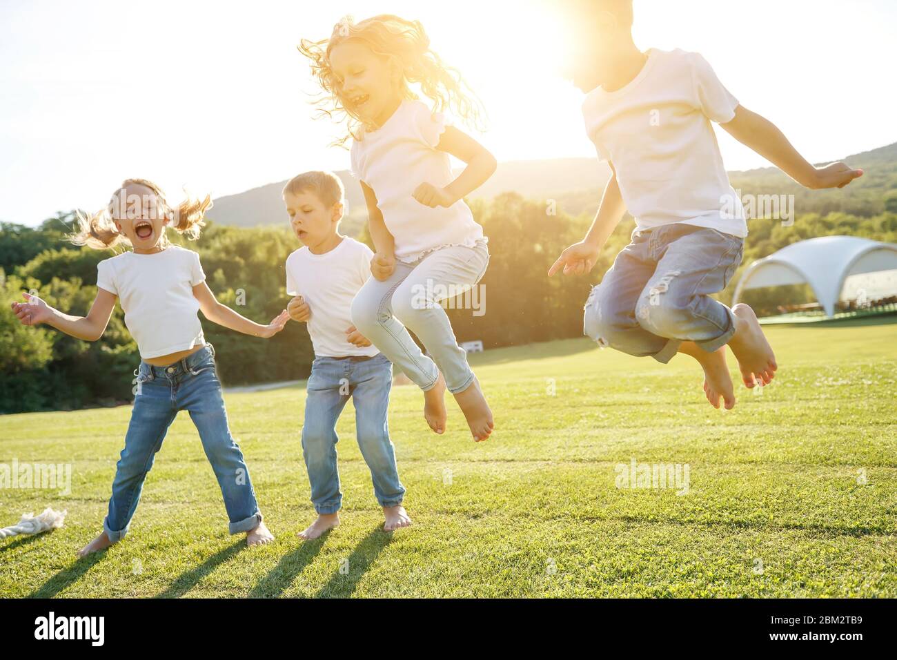 Children have fun playing in nature Stock Photo - Alamy