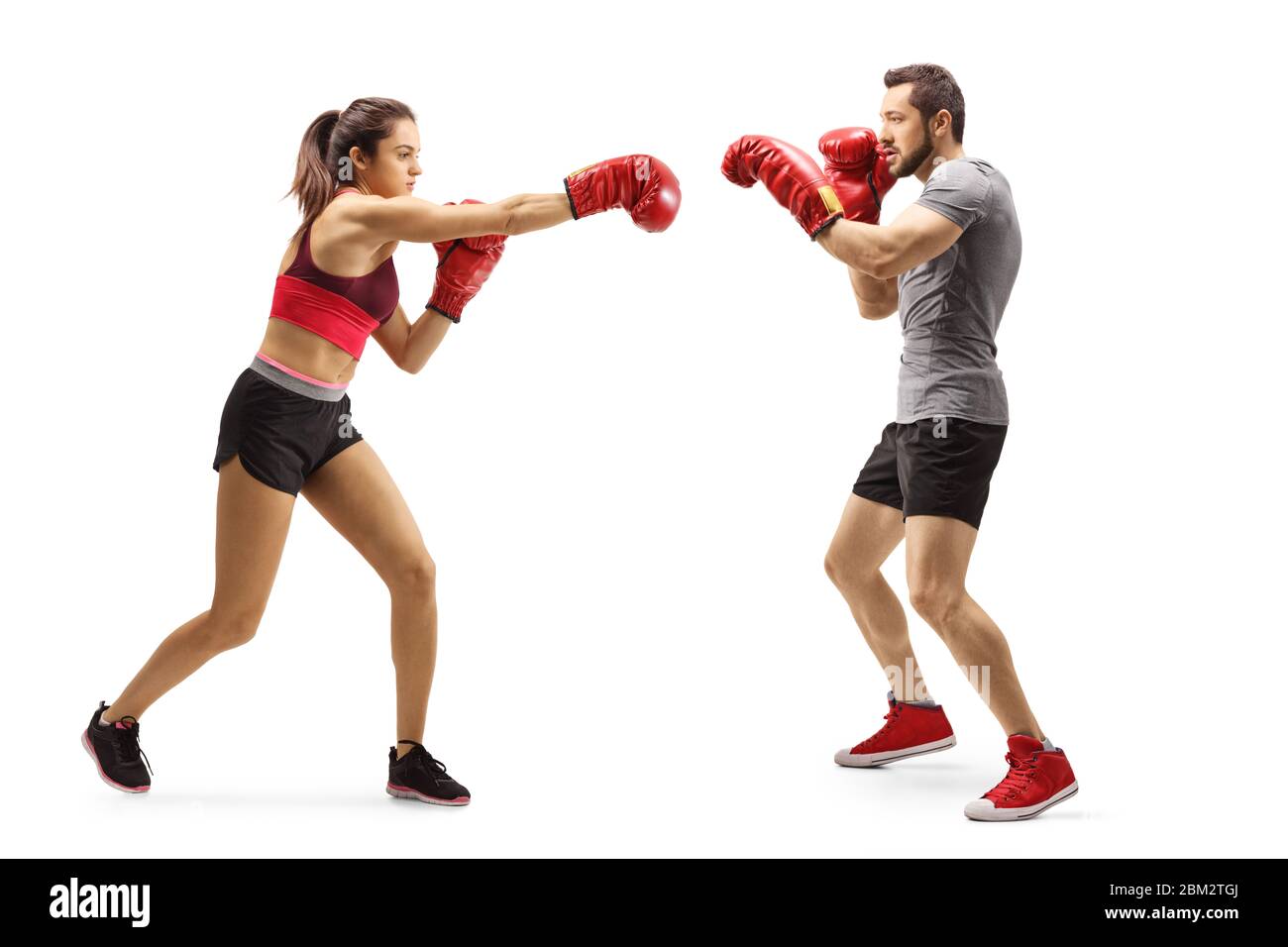 Full length shot of man and woman practicing boxing isolated on white ...