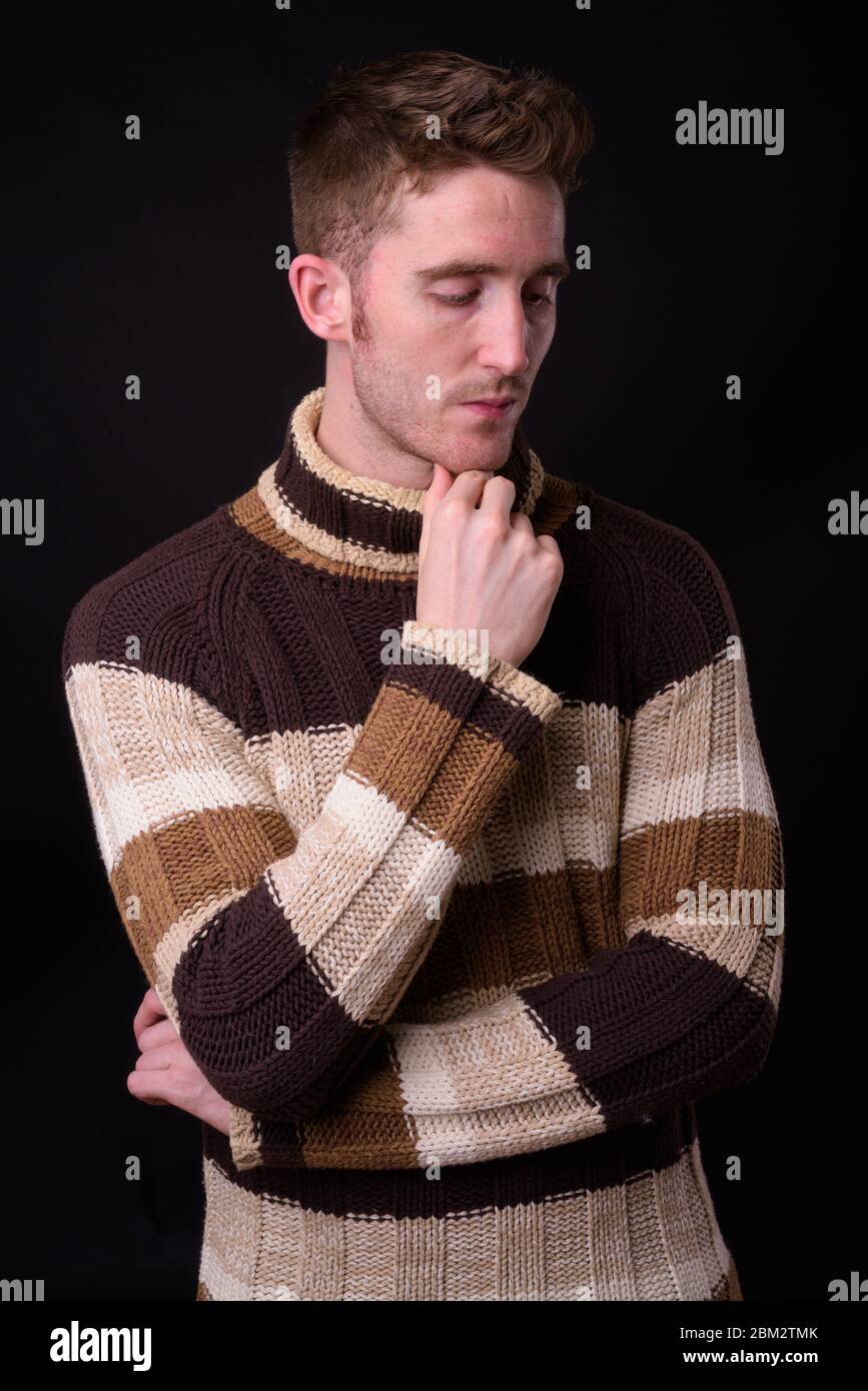 Stressed young man thinking and looking down for winter Stock Photo - Alamy