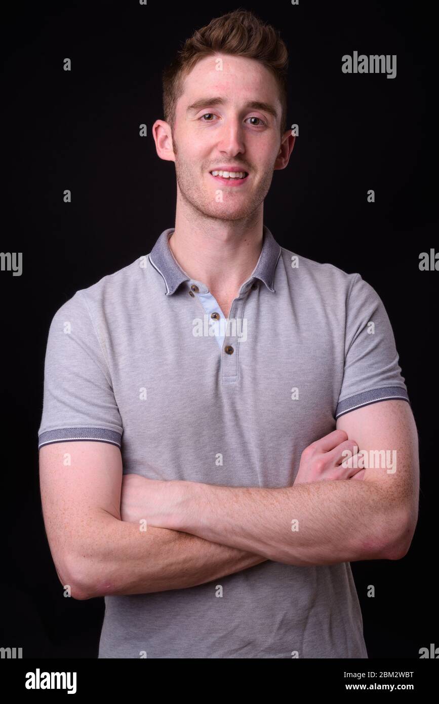 Portrait of happy young handsome man smiling with arms crossed Stock ...