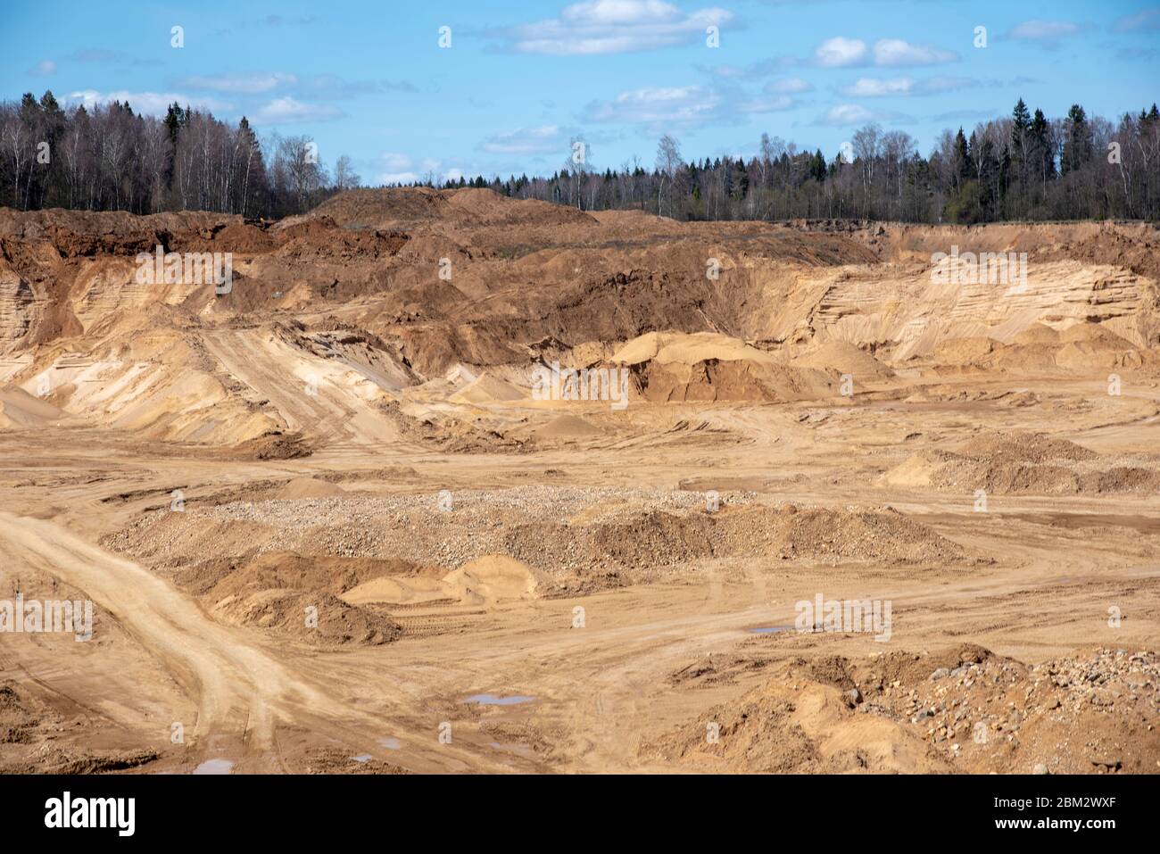 Sand deep quarry under a blue cloudy sky Stock Photo - Alamy