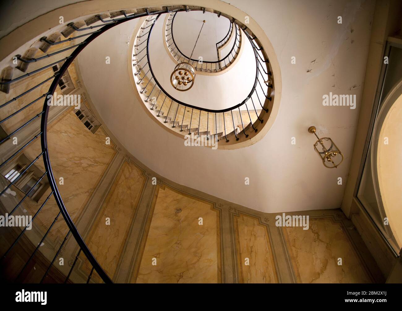Grand elicoidal staircase inside ancient residential building in Paris ...