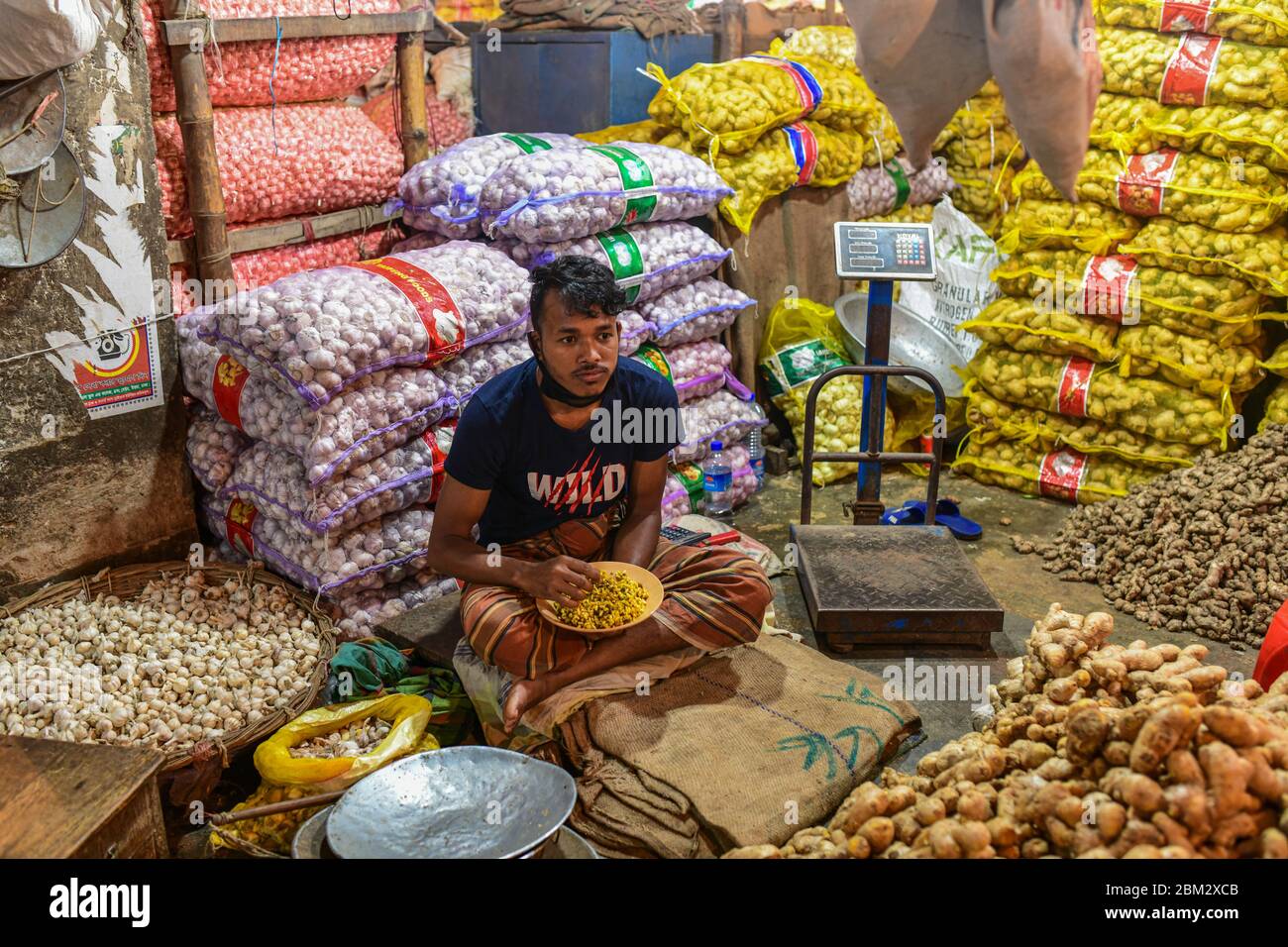 Workers of a wholesale market having fast-breaking dinner (Iftar) during Ramadan at their work ...