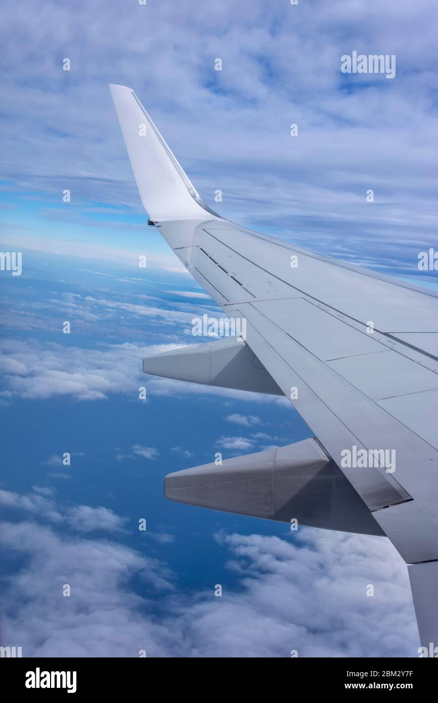 Aerial view of airplane flying above shade clouds and sky. Airplane ...