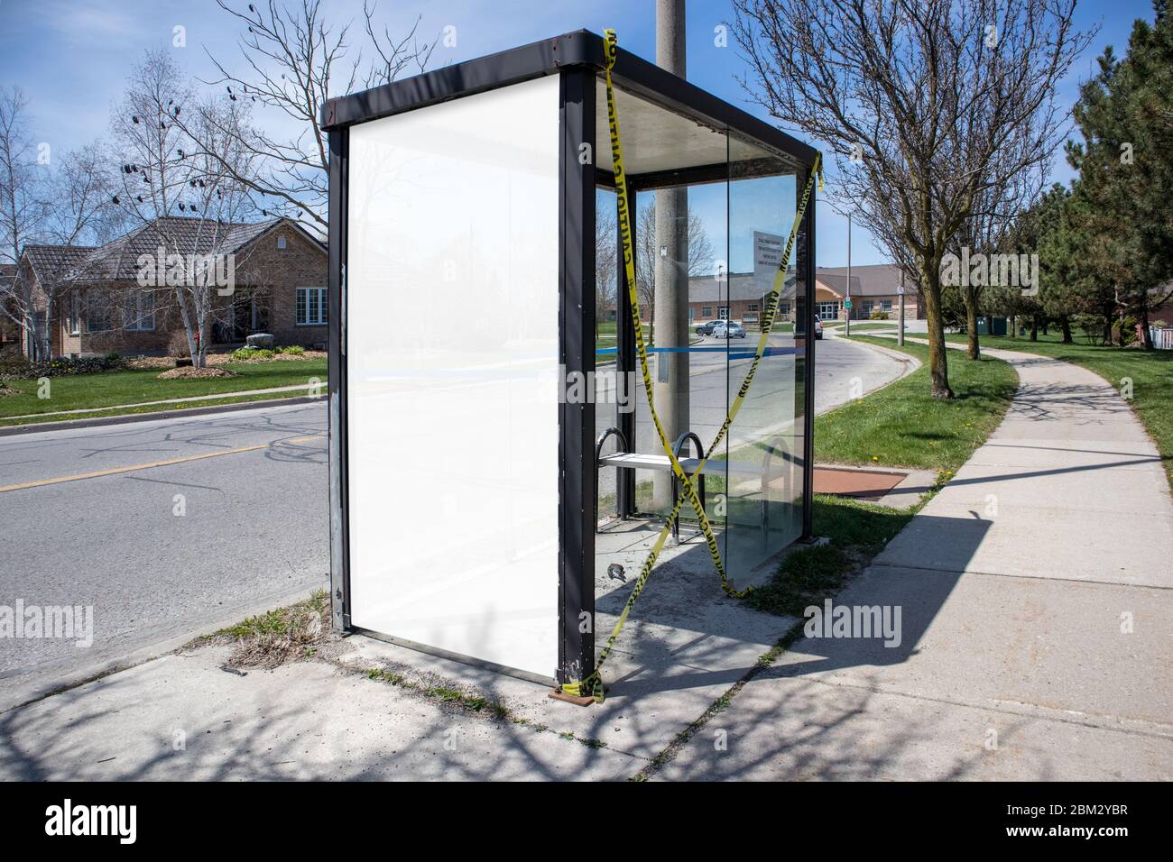 Closed bus shelter, blank billboard, empty street Stock Photo - Alamy