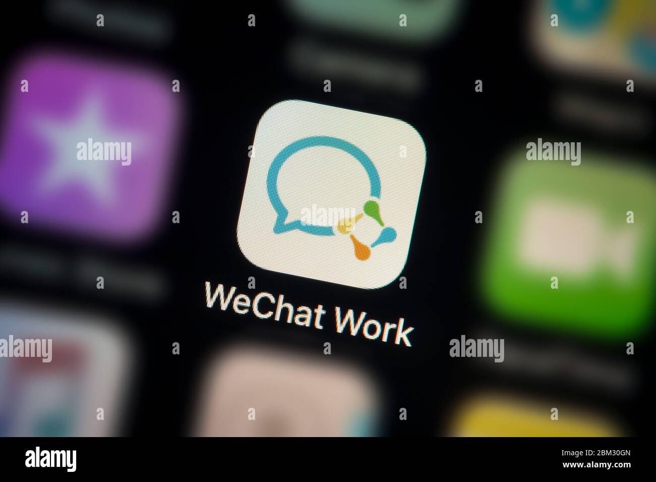 A close-up shot of the WeChat Work app icon, as seen on the screen of a ...