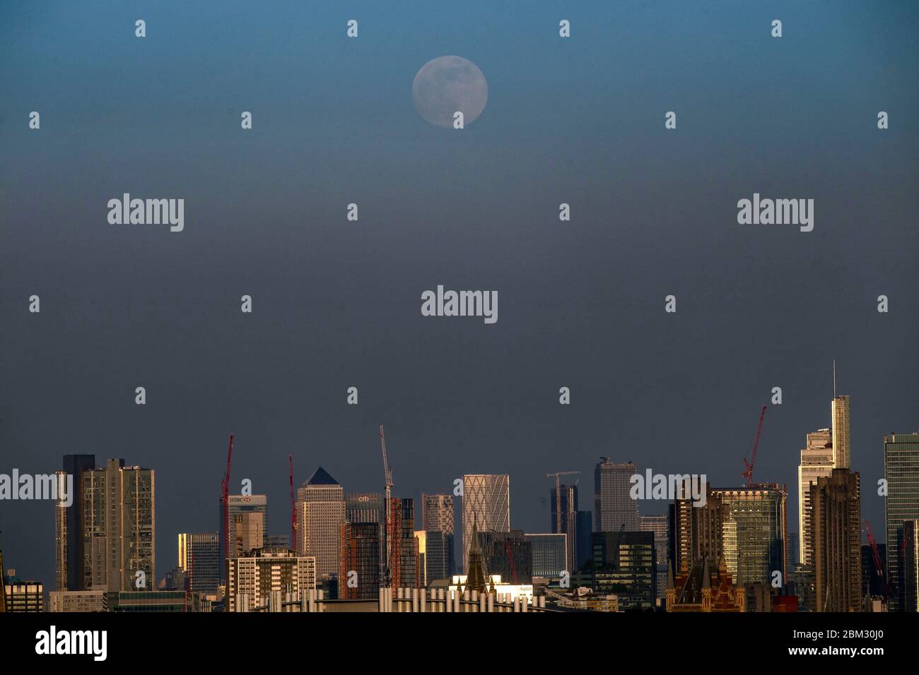 The moon rises over the City of London, ahead of the final supermoon of ...
