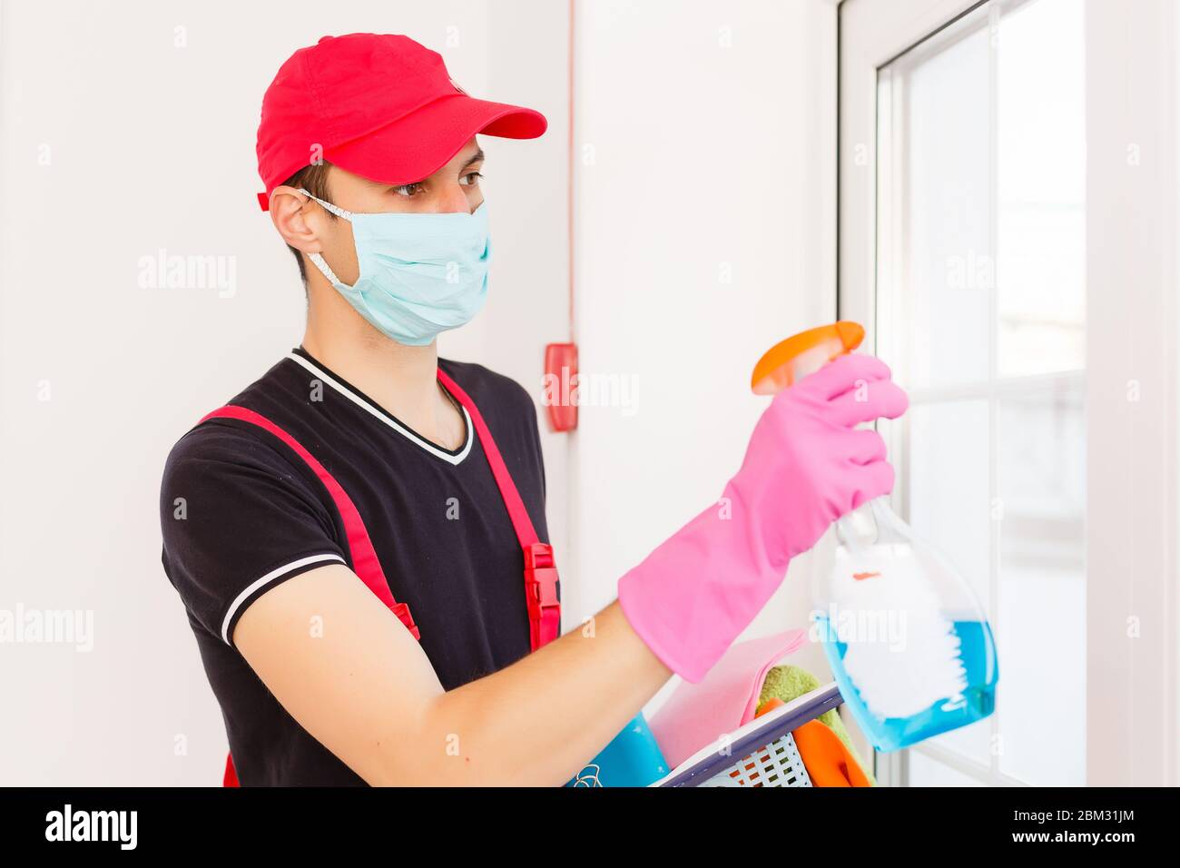 Disinfection For Virus Killing. Worker in Protection Mask cleaning ...