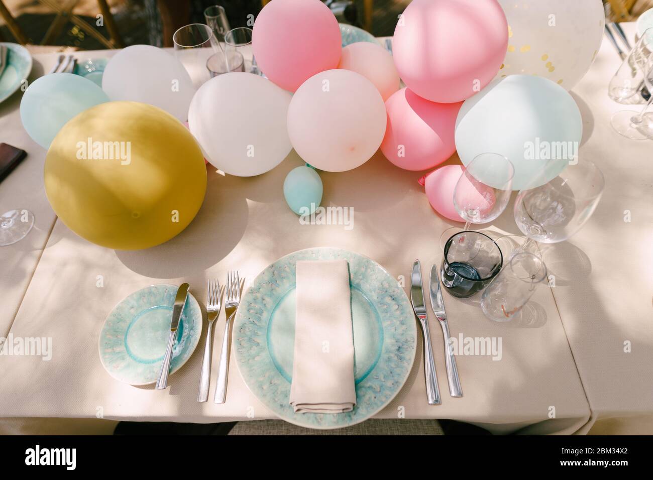 Wedding dinner table reception. Blue plates with a pattern and a napkin ...