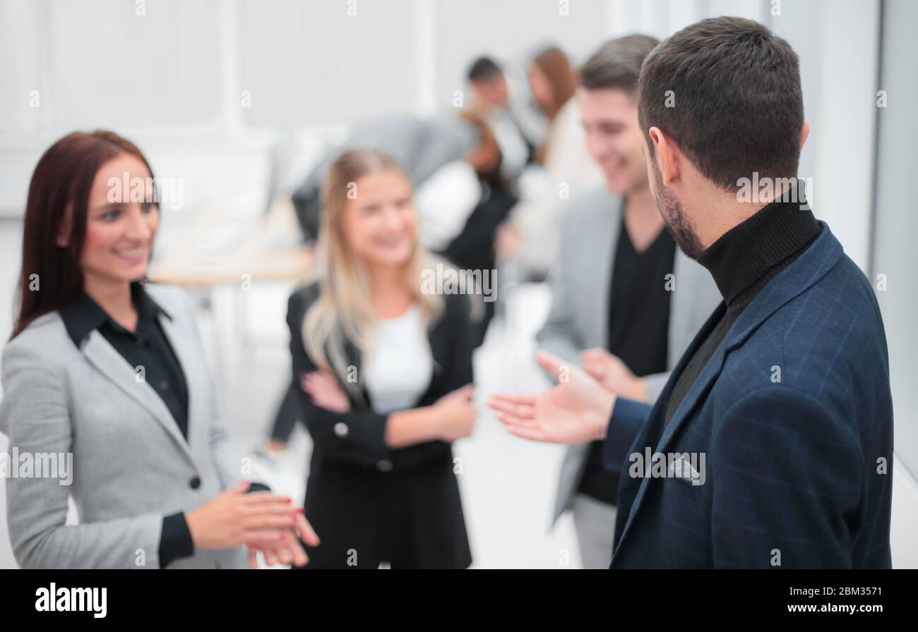 project Manager is talking to employees in the office Stock Photo - Alamy