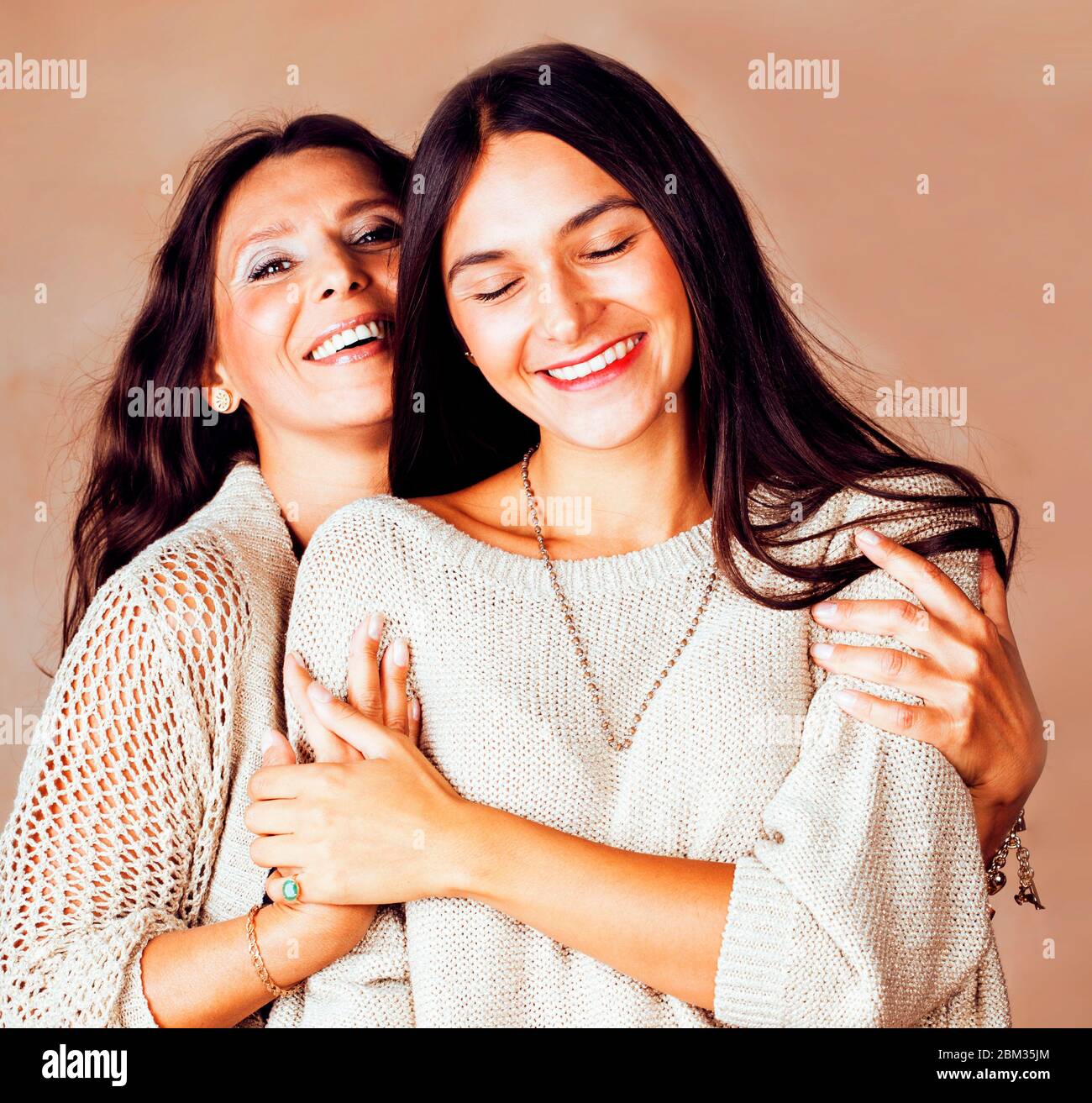 cute pretty teen daughter with mature mother hugging, fashion style ...