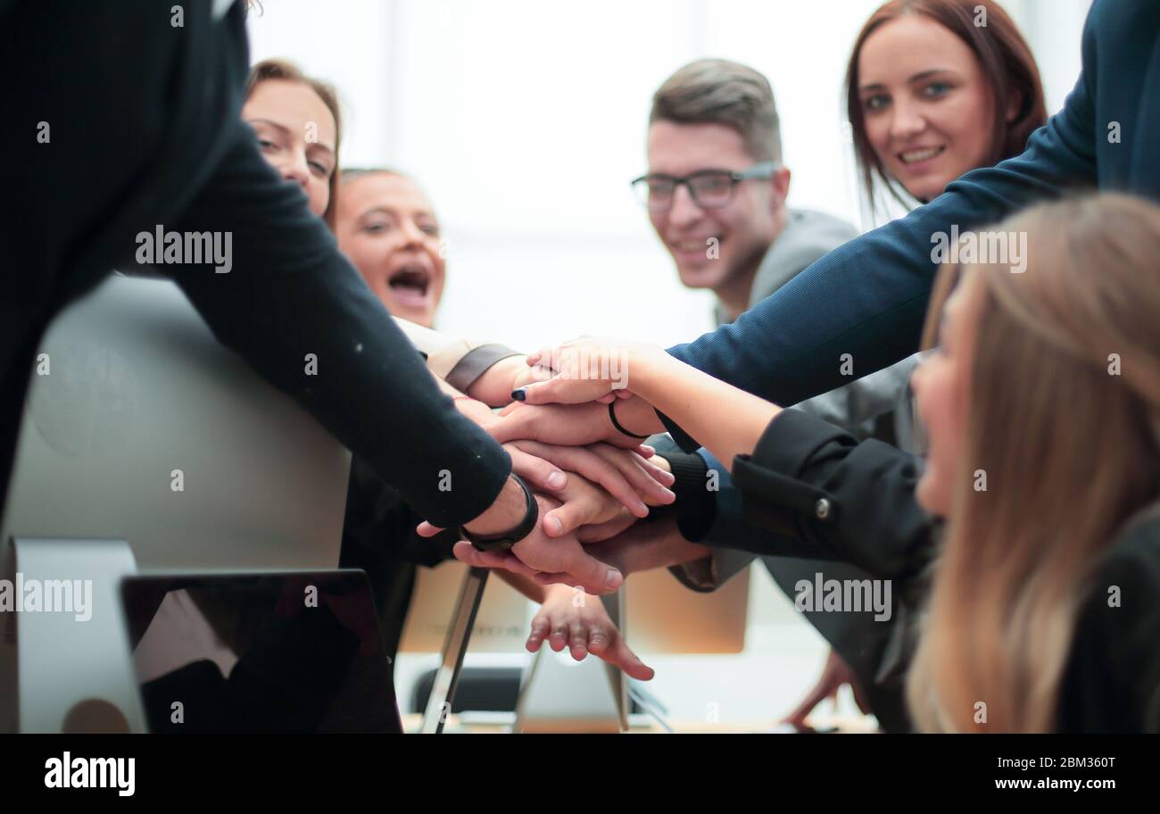 group of employees forming a stack of hands on the desktop Stock Photo ...