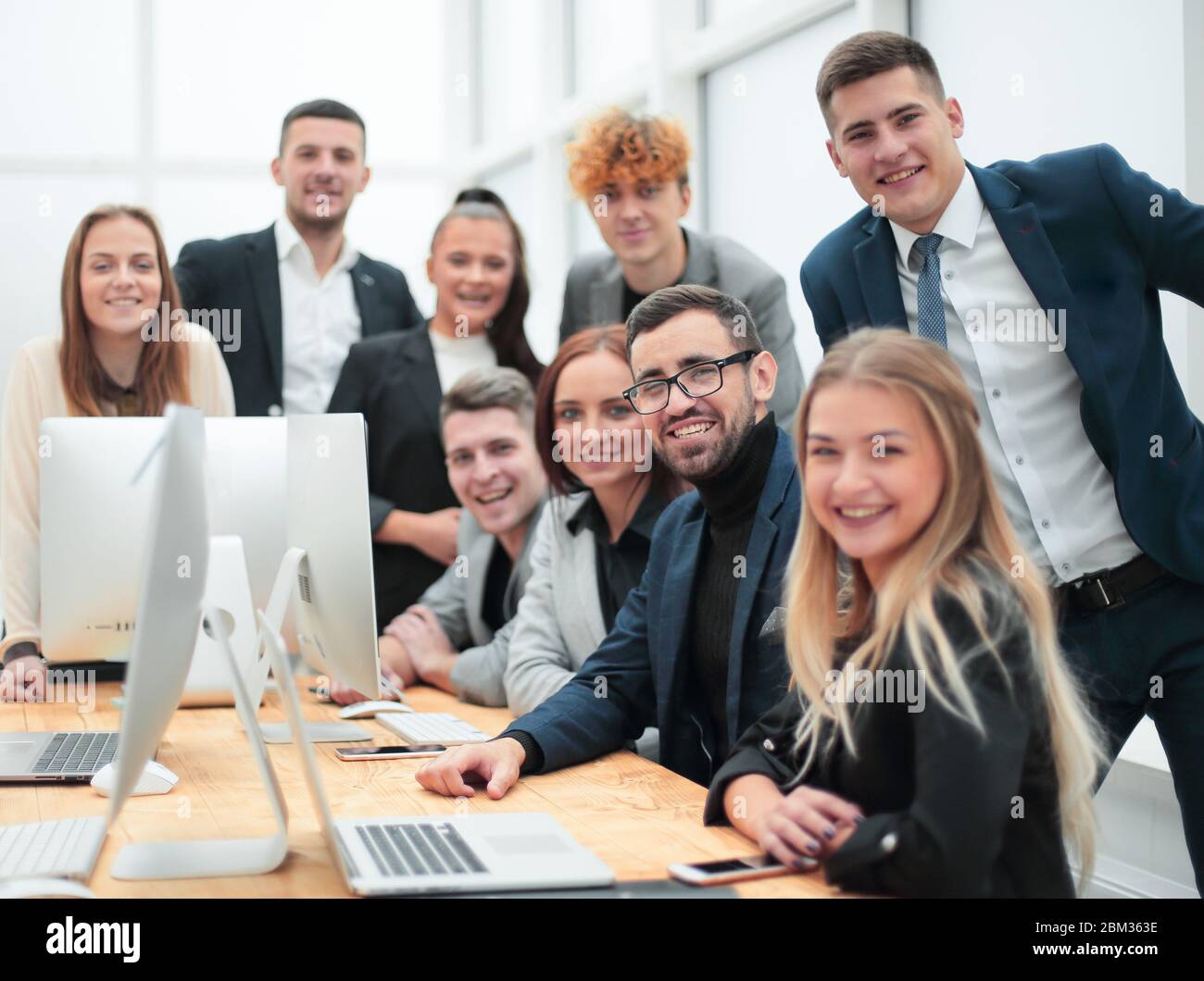 large group of employees in the workplace in the office Stock Photo - Alamy