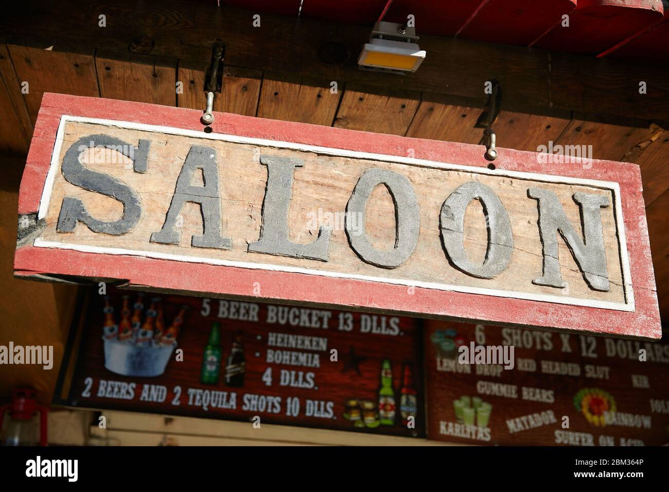 A colorful and fun saloon sign welcomes tourists at a bar in Cabo San ...