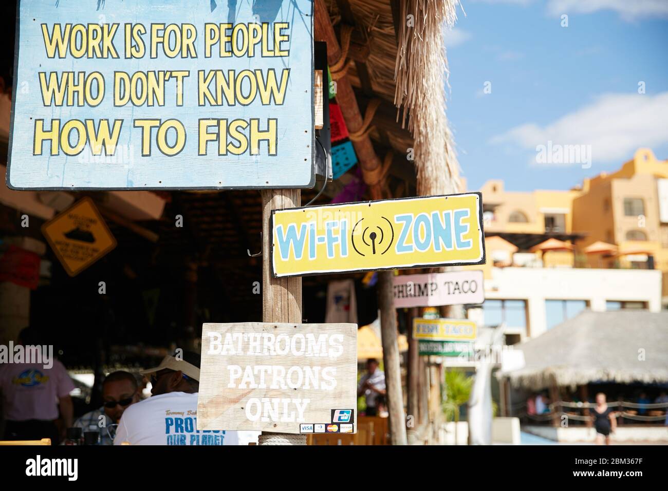 Colorful and fun signs await tourists at bars in Cabo San Lucas, Mexico ...