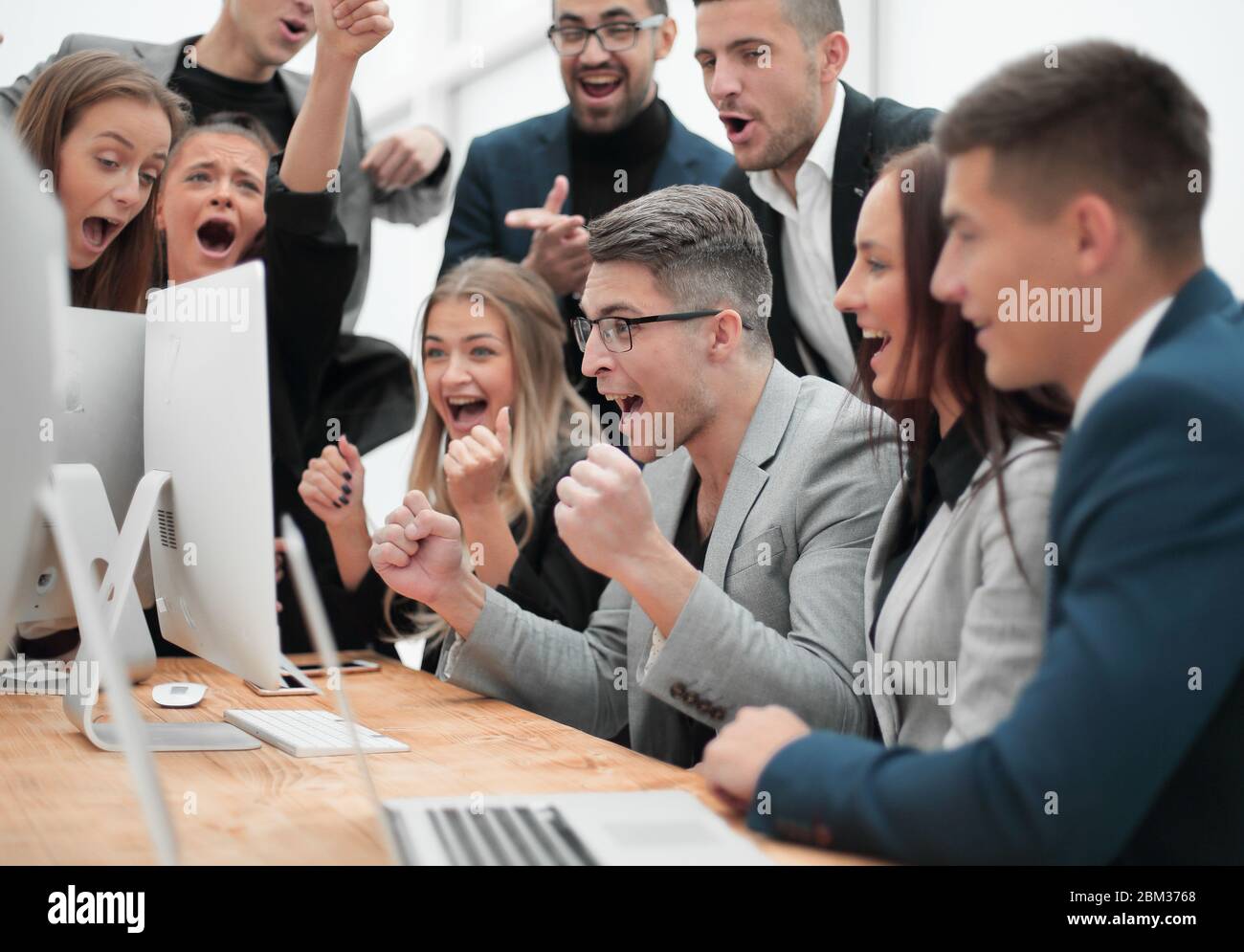 jubilant business team looking at the computer monitor Stock Photo - Alamy