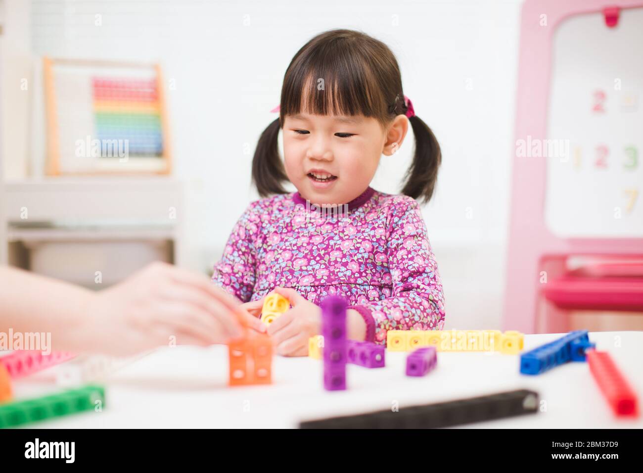 toddler girl play number blocks for homeschooling Stock Photo - Alamy