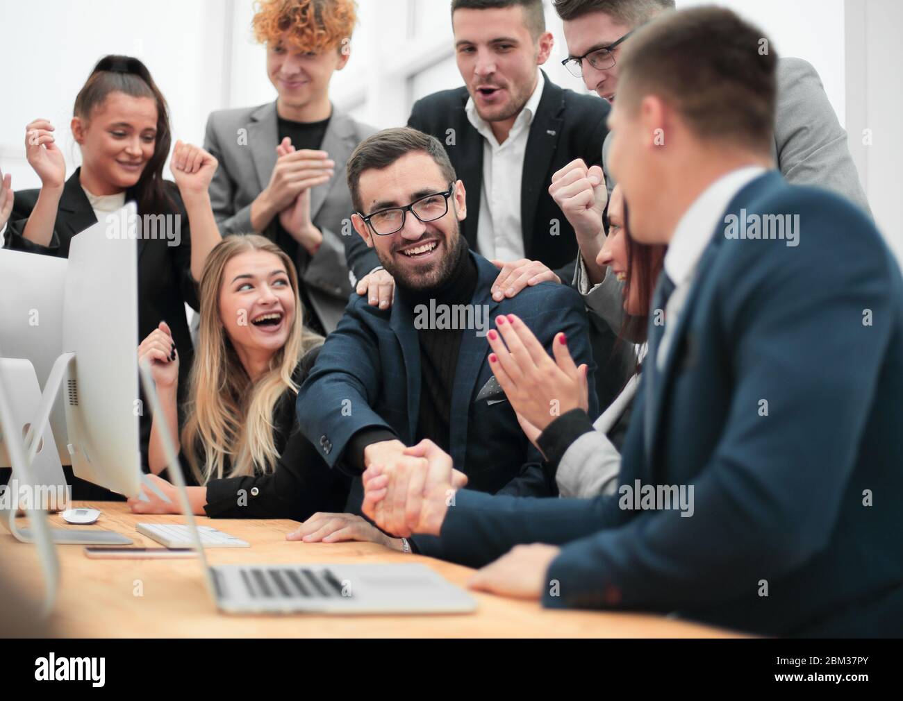 happy business colleagues shaking hands with each other Stock Photo - Alamy