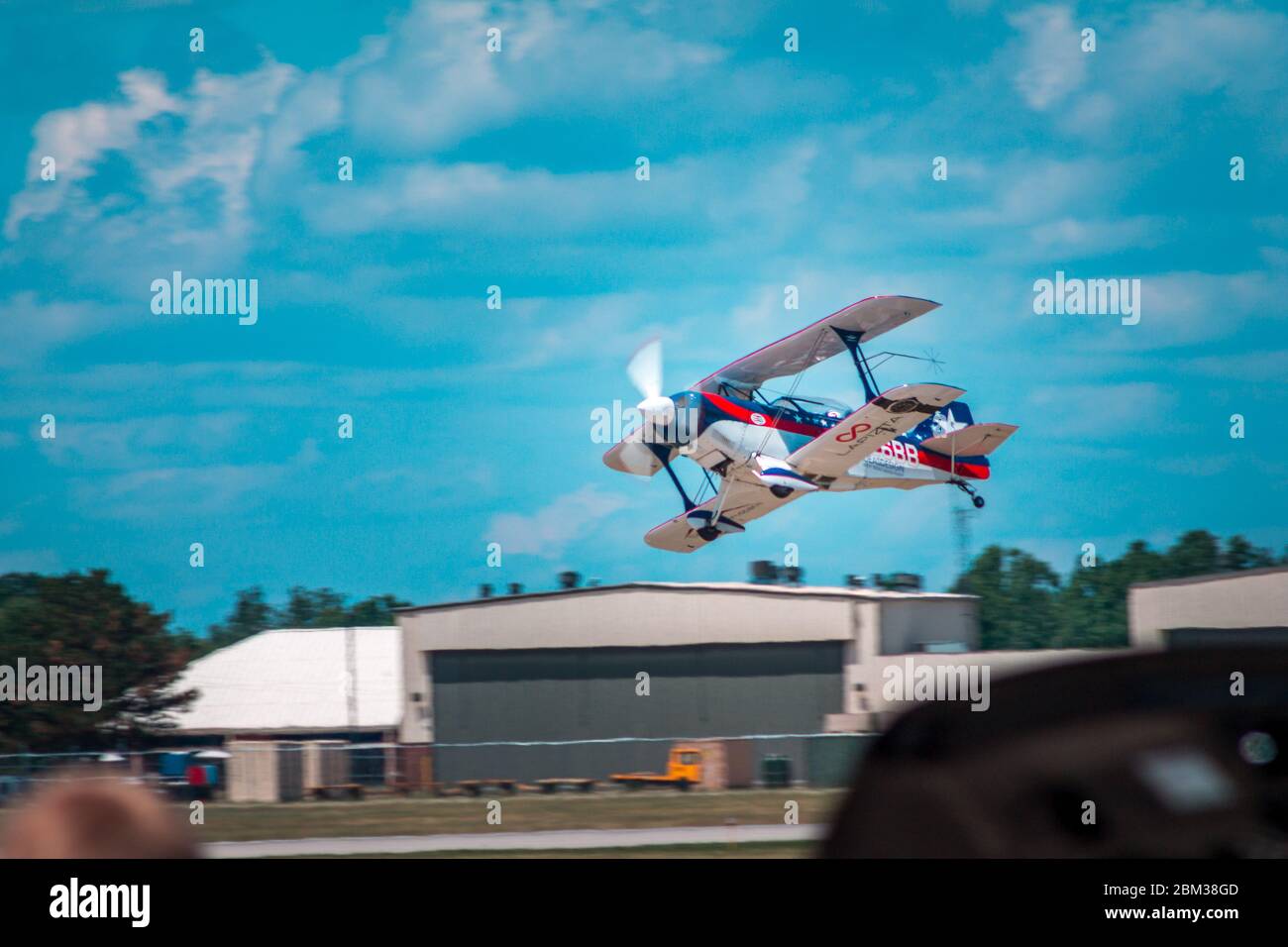 Biplane doing tricks low o the ground at an airshow in Battle Creek ...