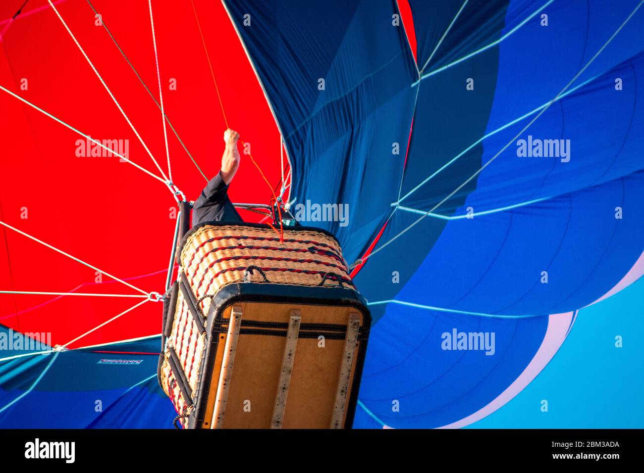 Hot air balloon pilot soaring above in the sky Stock Photo - Alamy