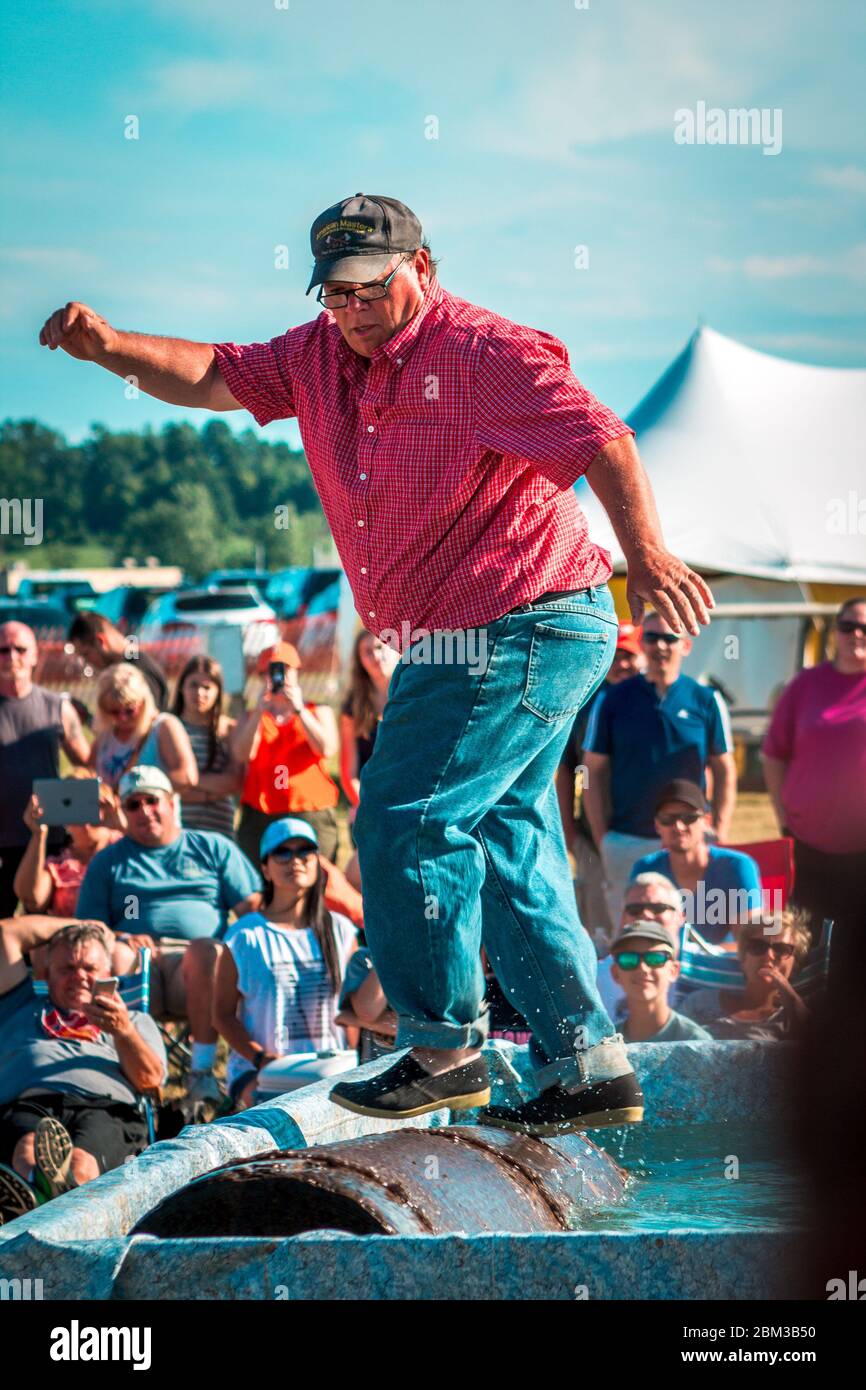 Man log rolling at an airshow in Battle Creek Michigan Stock Photo - Alamy