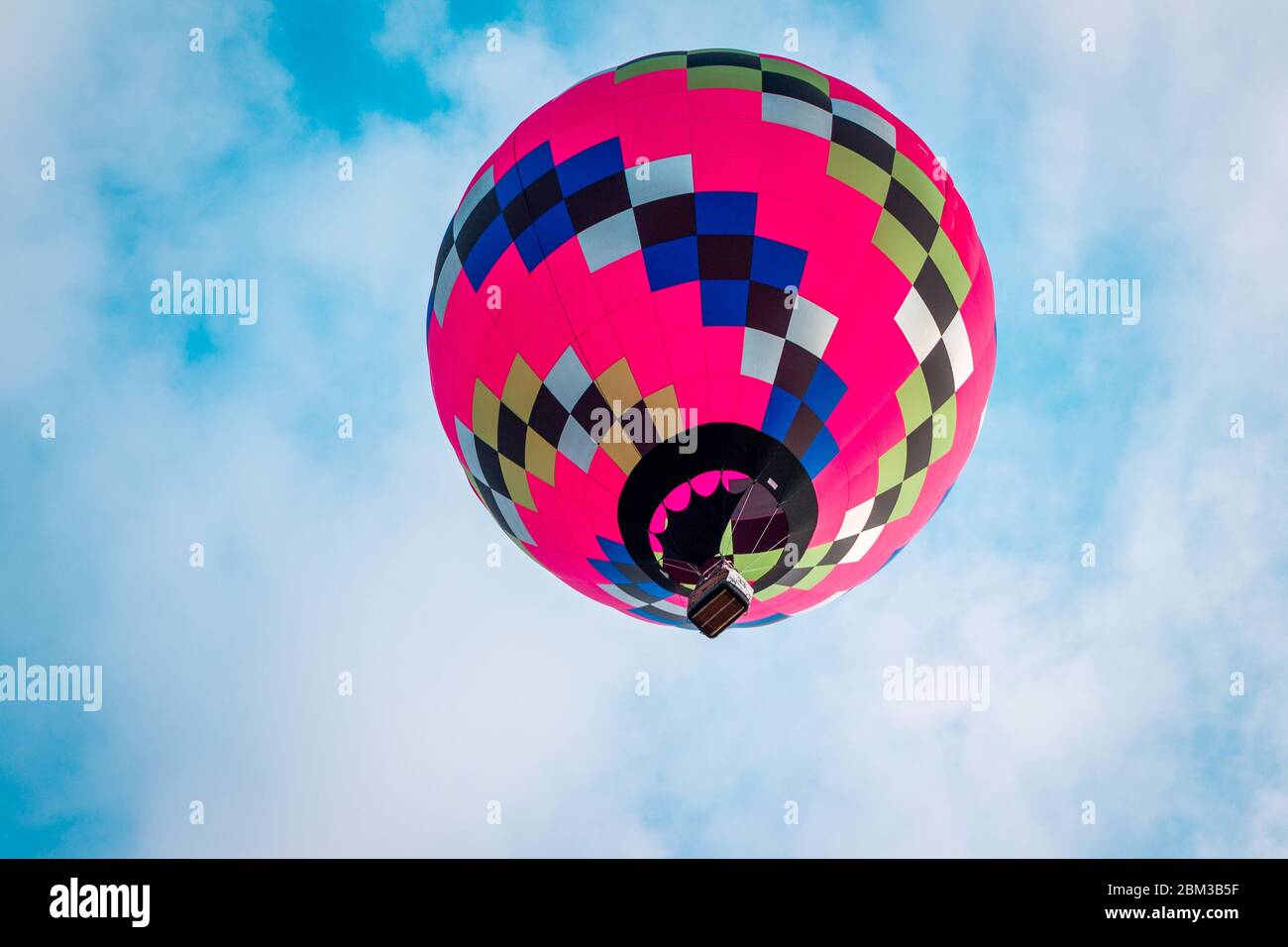Pink hot air balloon floating overhead at an airshow Stock Photo - Alamy