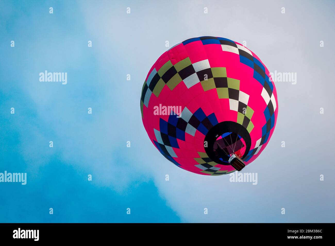 Pink hot air balloon floating overhead Stock Photo - Alamy