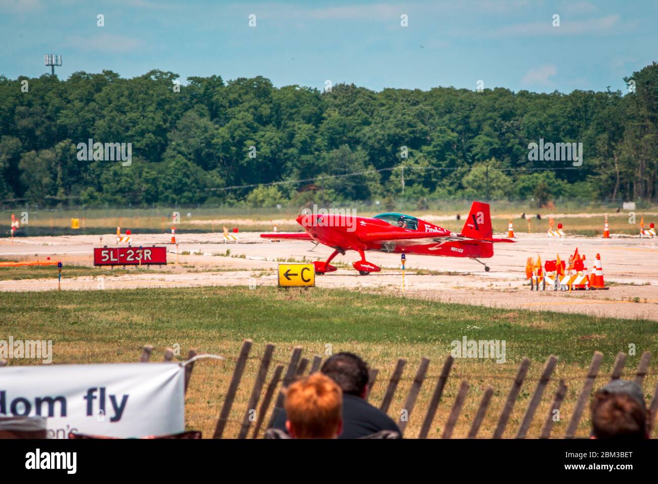 Red jet landing at at airshow Stock Photo - Alamy