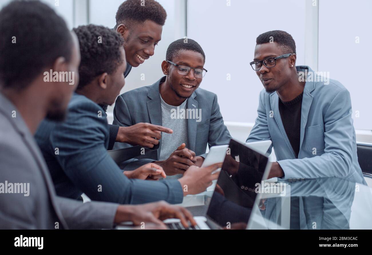 group of employees looking at the screen of a digital tablet Stock ...