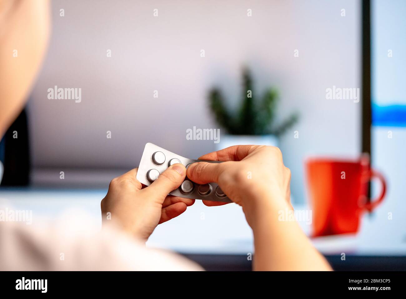 Woman taking tablet from blister hi-res stock photography and images ...